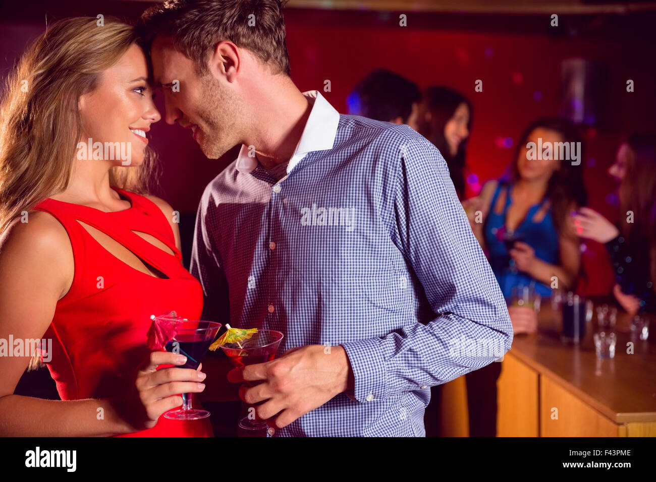 Cute couple drinking cocktails together Stock Photo - Alamy