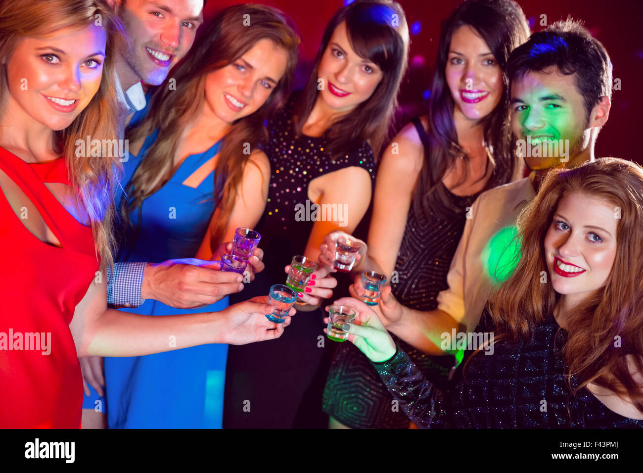 Happy friends on a night out together Stock Photo - Alamy