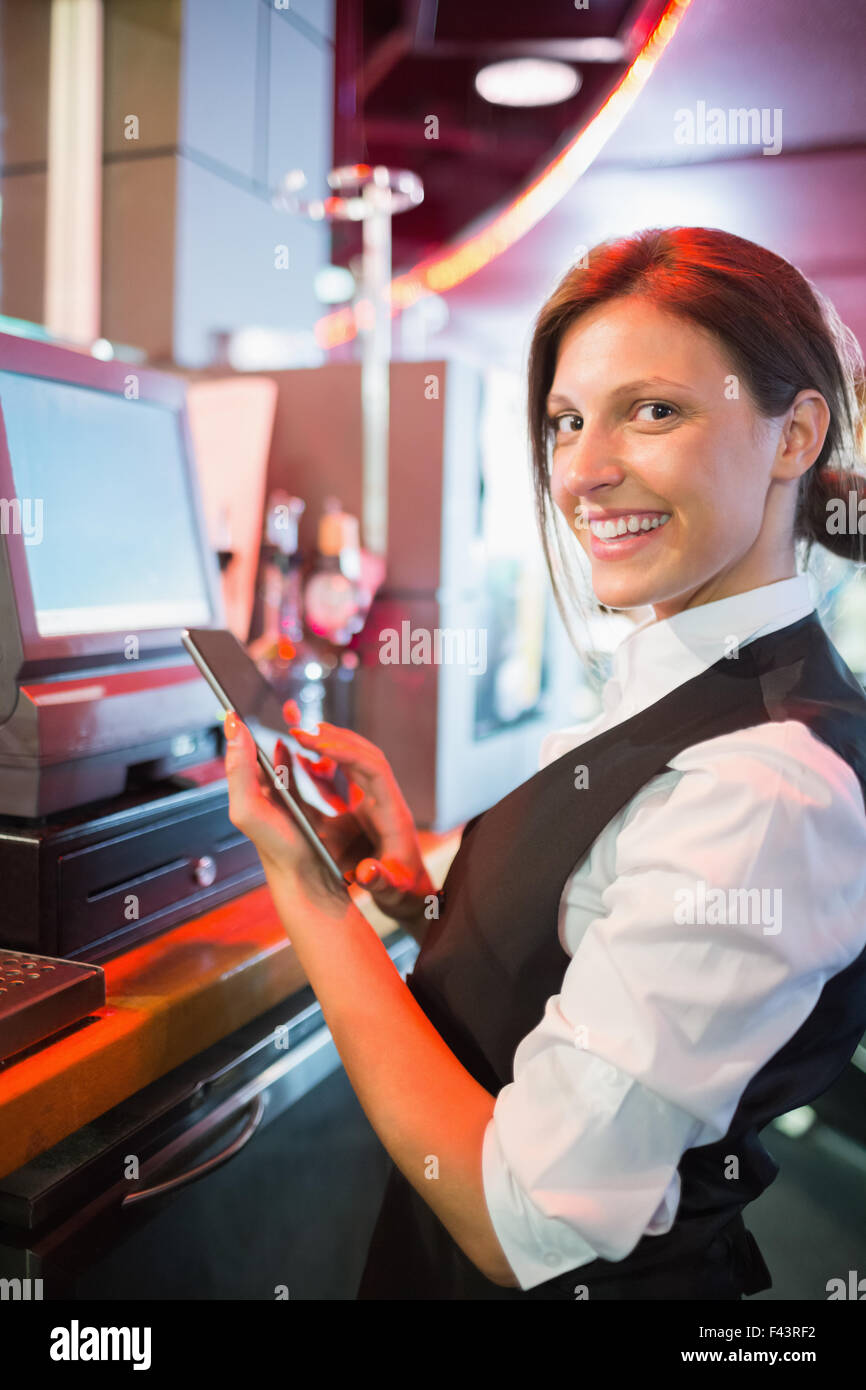 Pretty barmaid using touchscreen till Stock Photo - Alamy