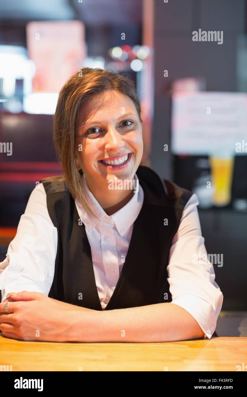 Pretty barmaid smiling at camera Stock Photo - Alamy