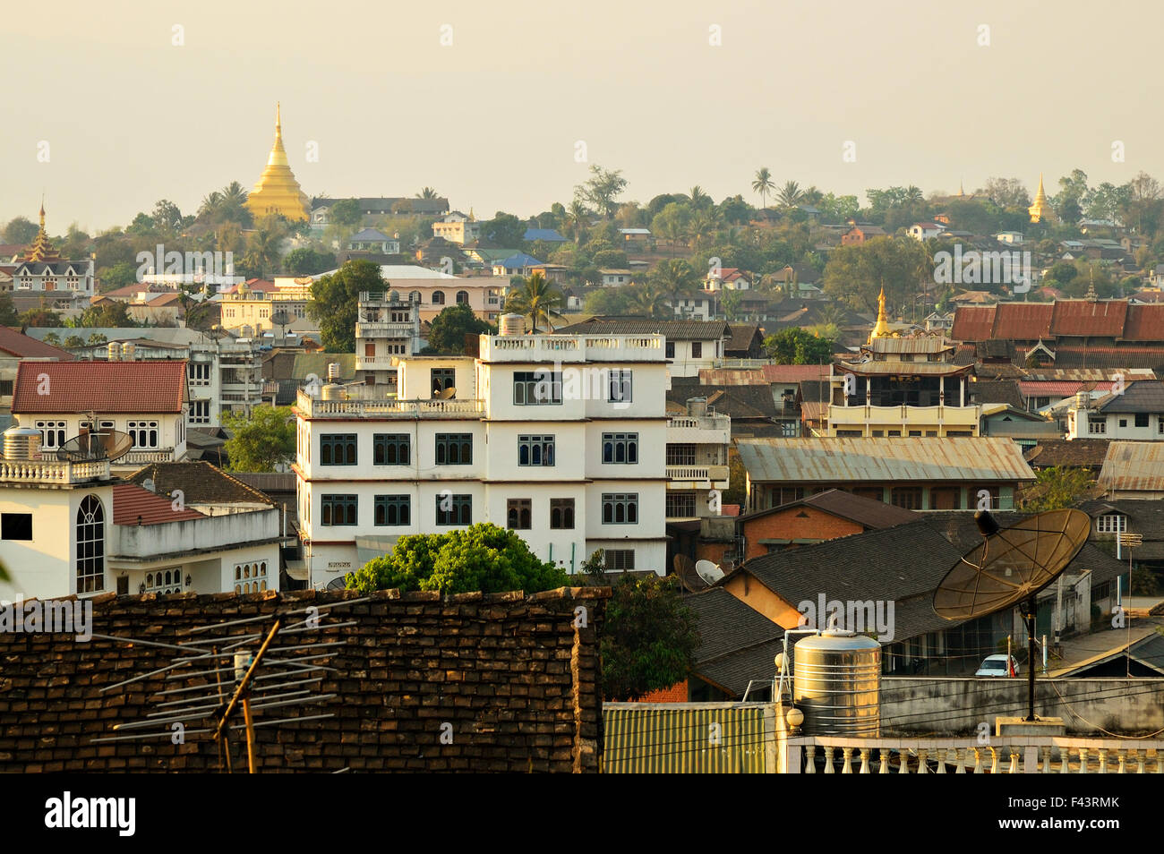 View over rooftops and stupas in Kengtung (Kyaingtong) at sunset, Shan ...