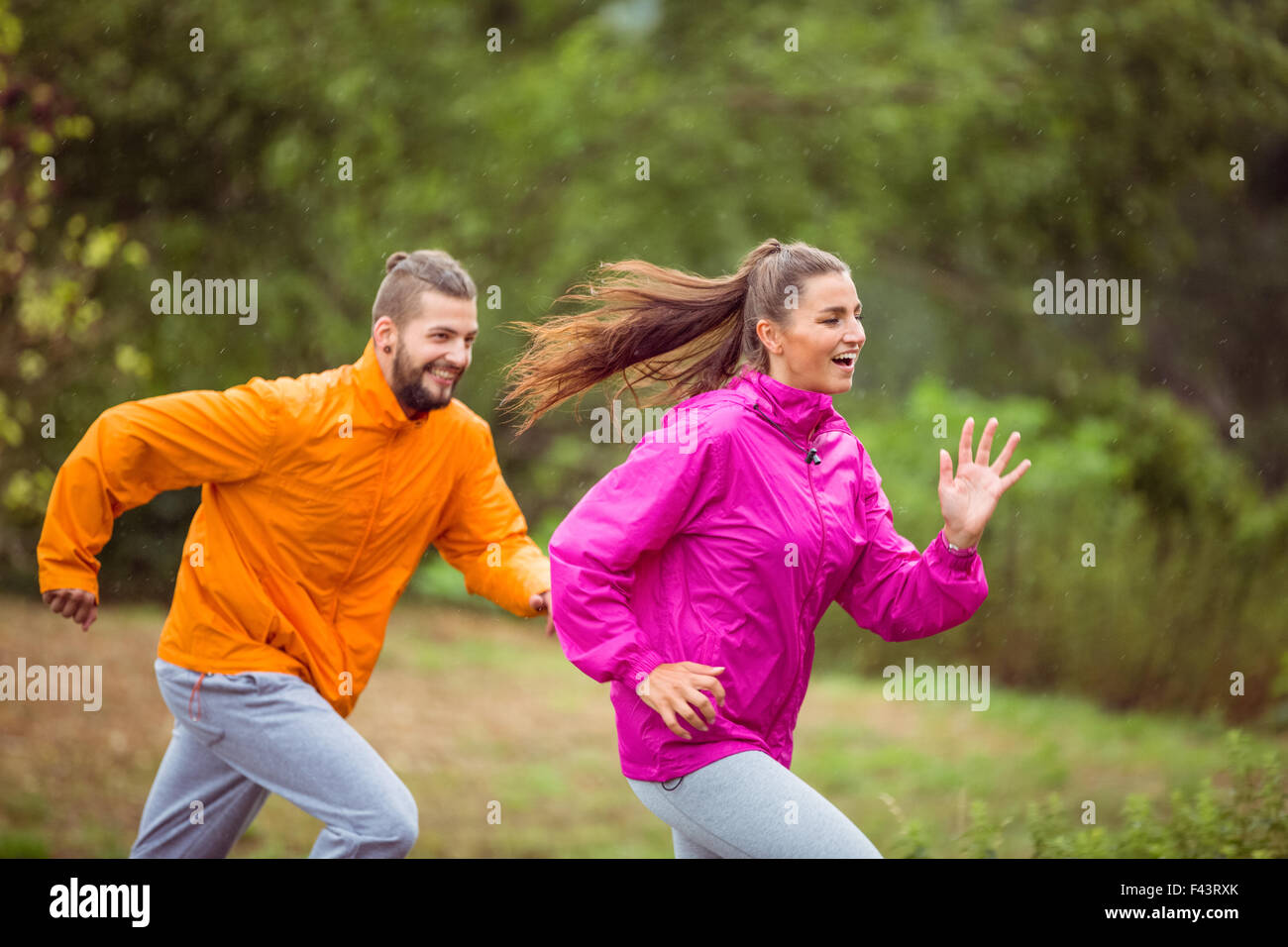 Happy couple running on a hike Stock Photo - Alamy