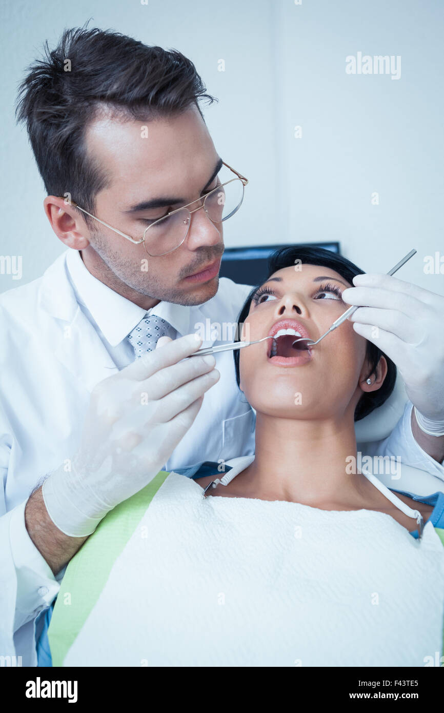 Dentist examining young womans teeth hi-res stock photography and ...