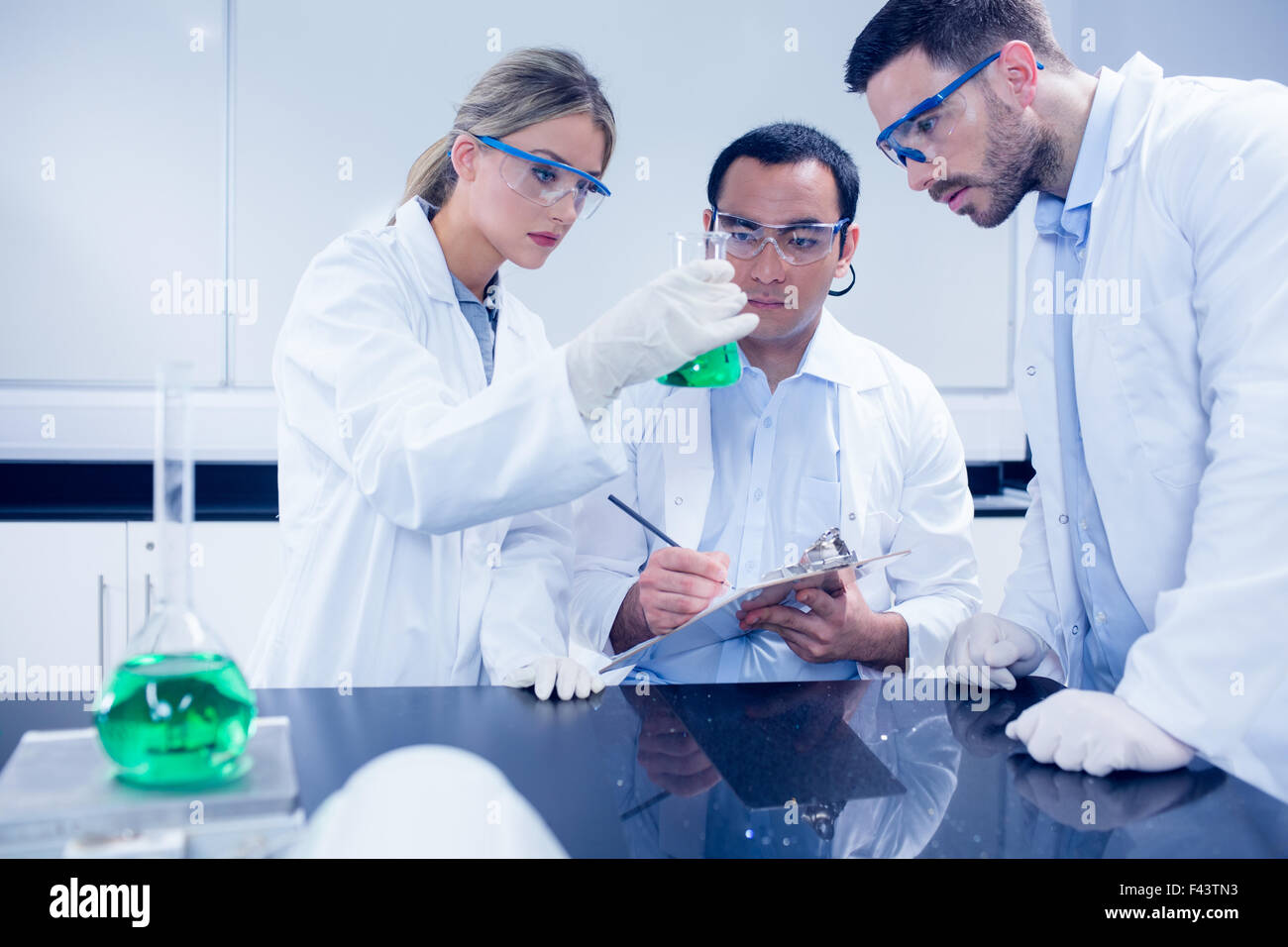 Science students working together in the lab Stock Photo - Alamy