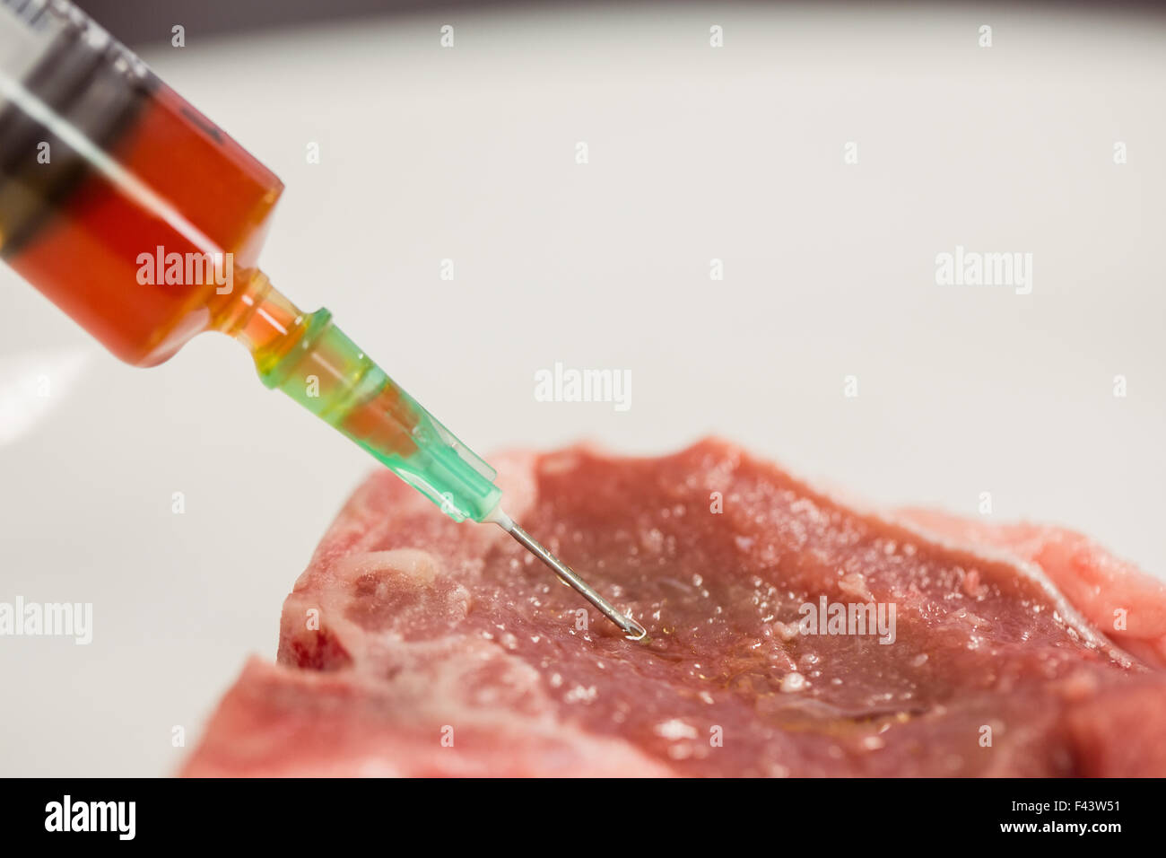 Food scientist injecting raw meat Stock Photo - Alamy