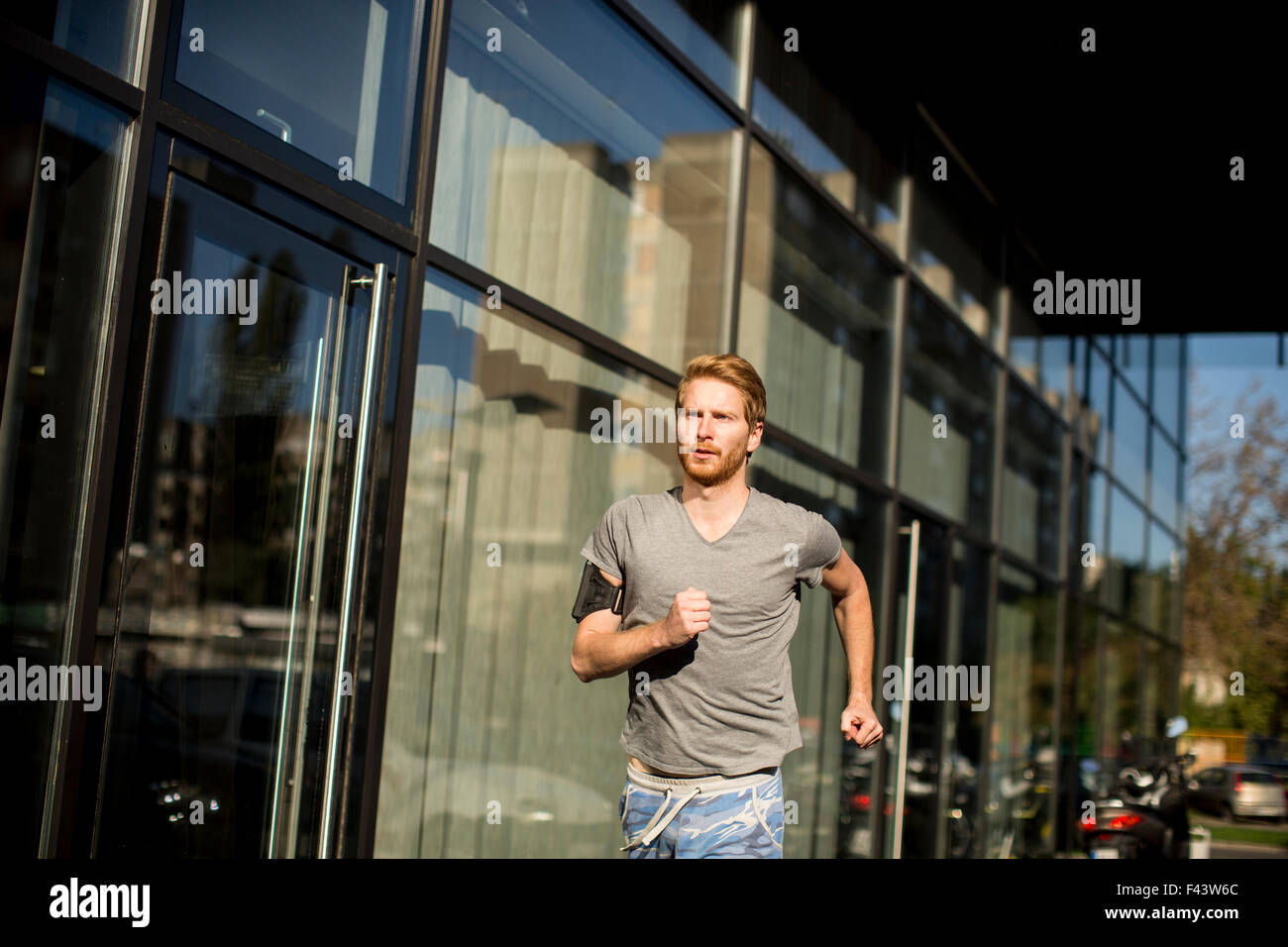 Young man running in the urban area Stock Photo - Alamy