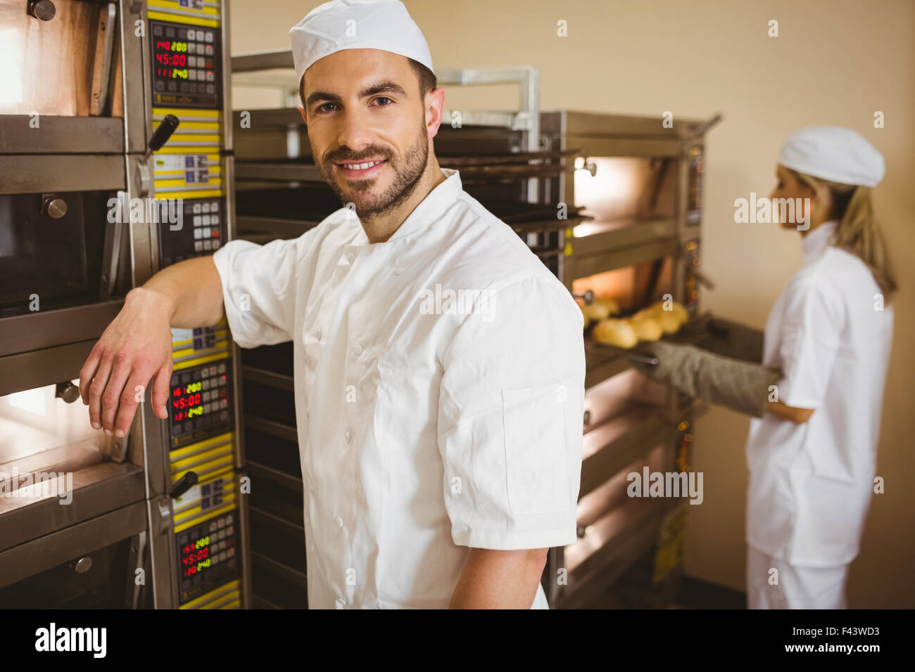 Handsome baker smiling at camera Stock Photo - Alamy