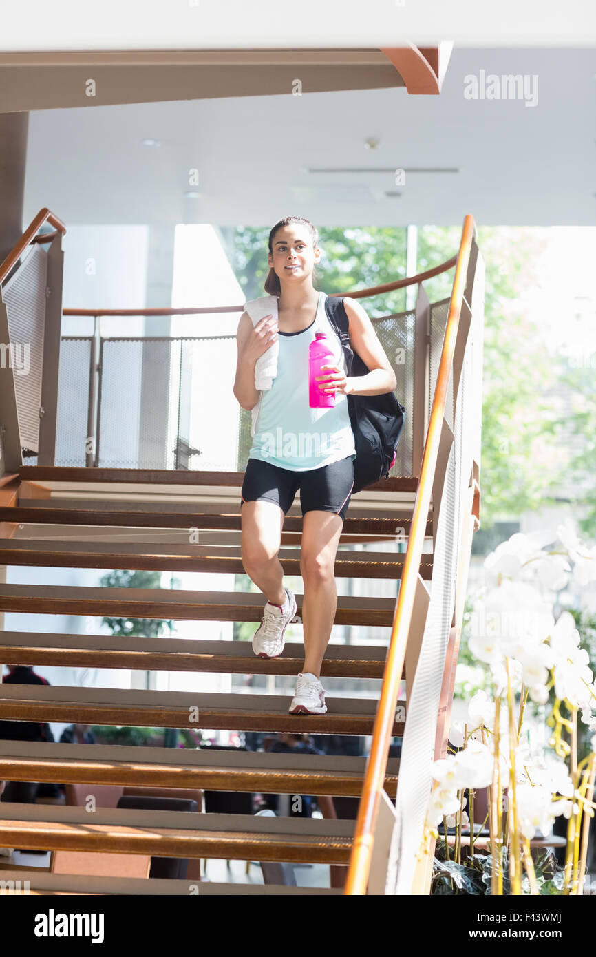 Woman walking down stairs Stock Photo - Alamy