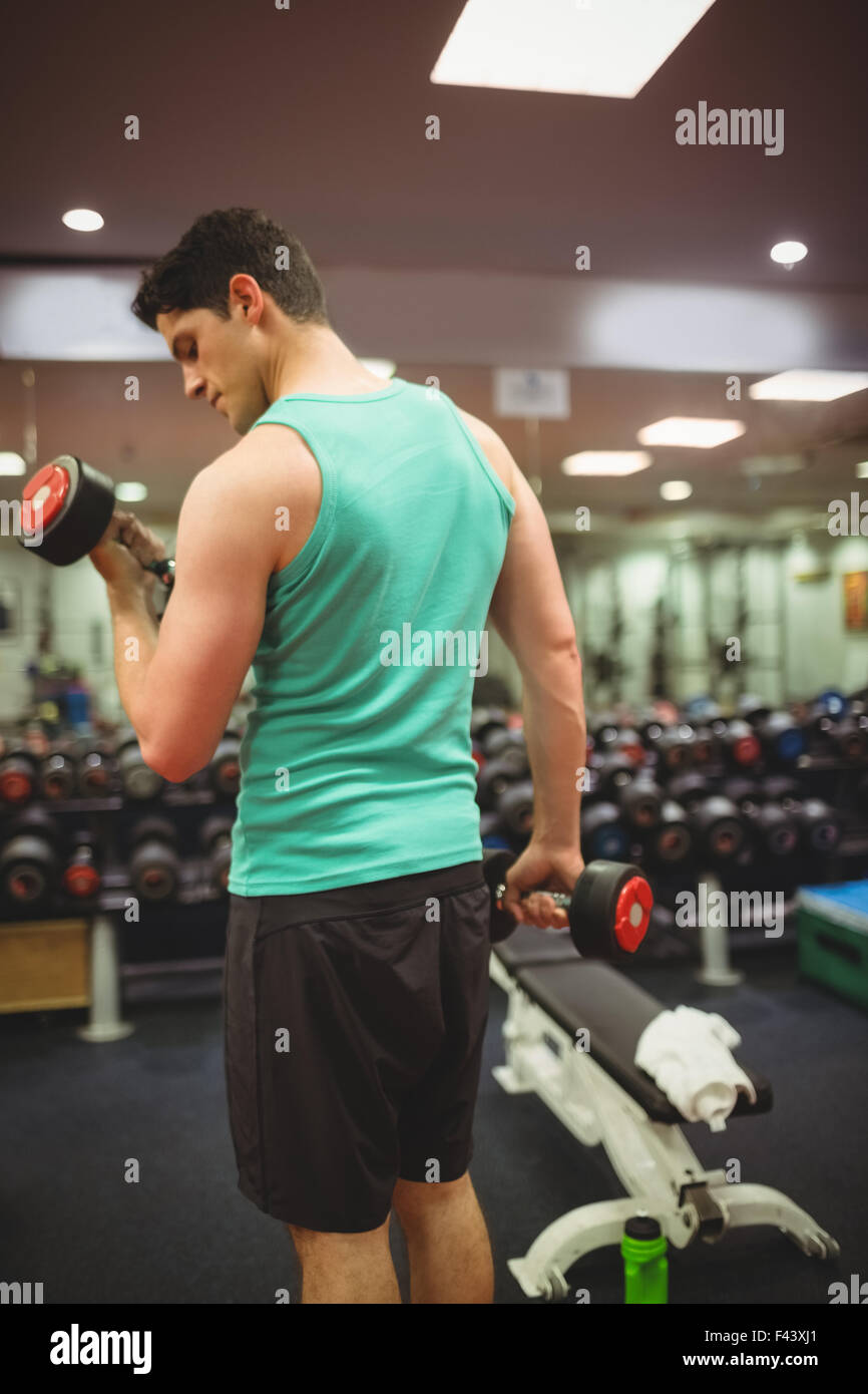Fit man lifting heavy black dumbbells Stock Photo - Alamy
