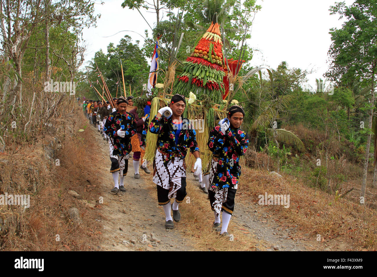 A number of men dressed in Java, brought crops in the form Gunungan, on ...