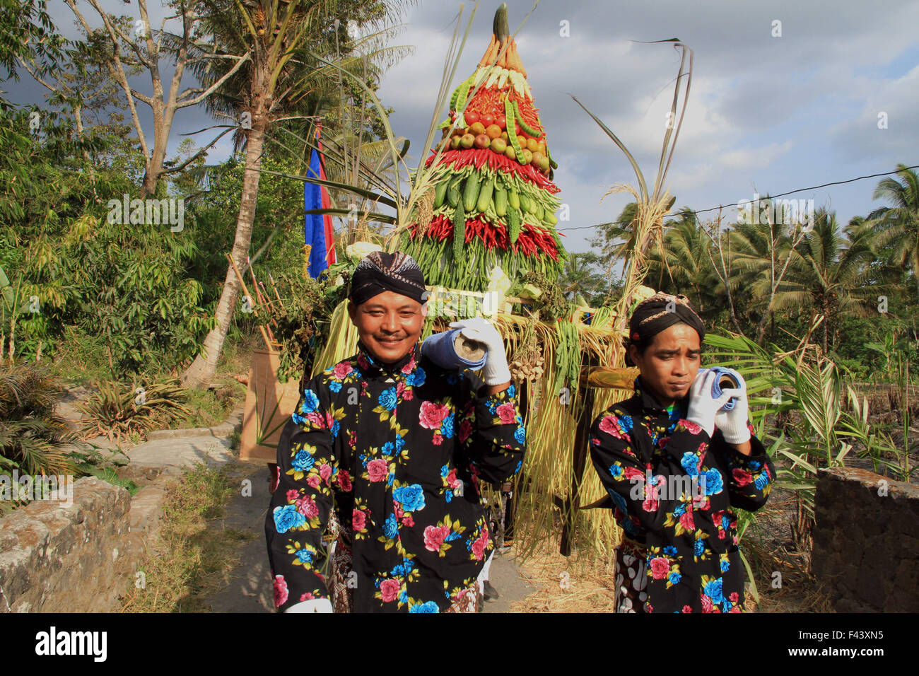 A number of men dressed in Java, brought crops in the form Gunungan, on ...