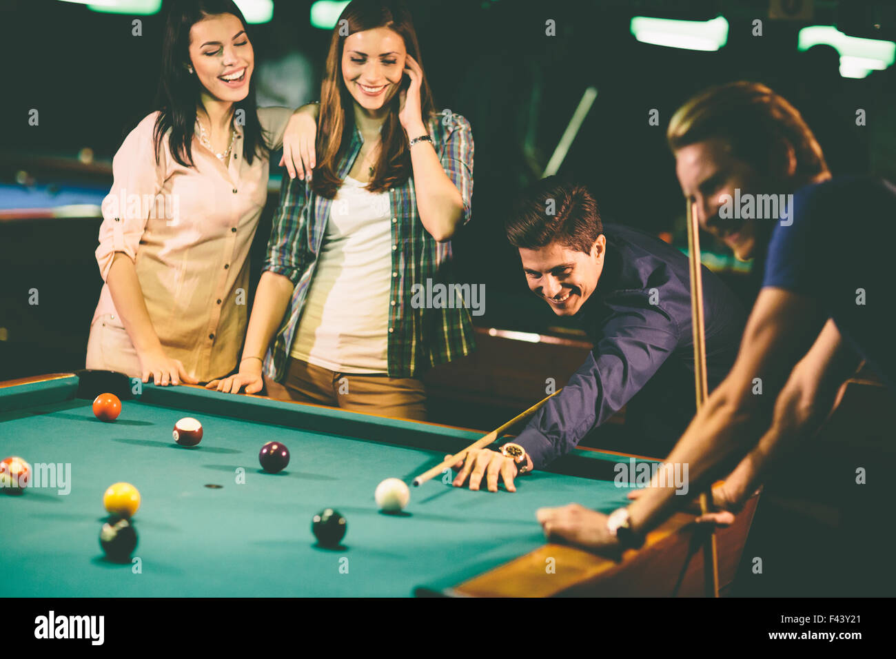 Young people playing pool Stock Photo - Alamy