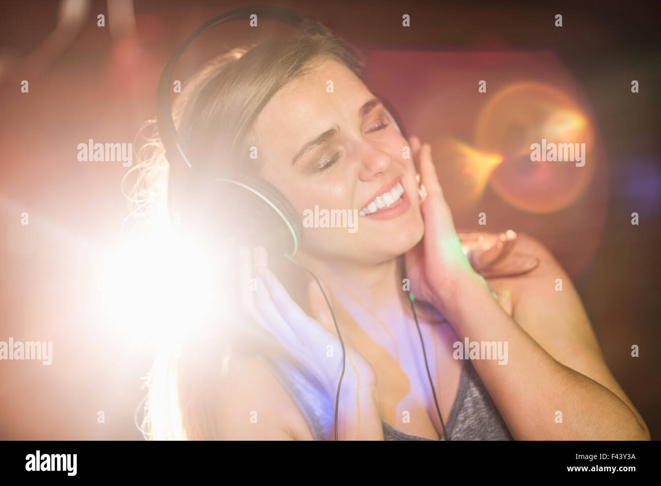 Pretty dj smiling and dancing Stock Photo - Alamy