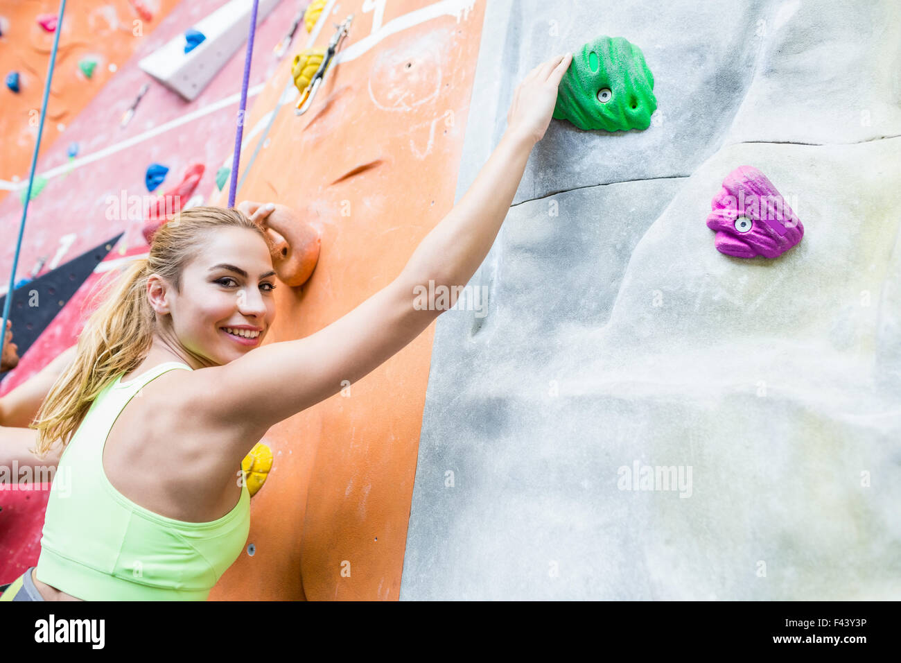 Fit people rock climbing indoors Stock Photo - Alamy
