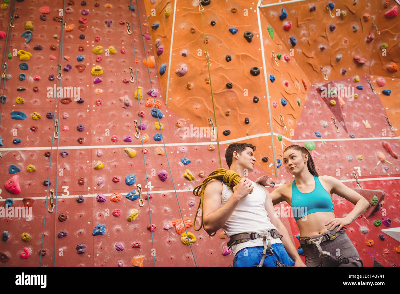 Fit couple at the rock climbing wall Stock Photo - Alamy