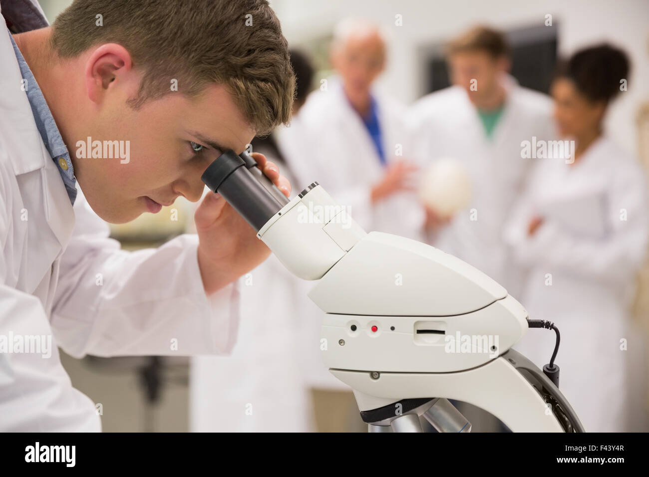 Young medical student working with microscope Stock Photo - Alamy