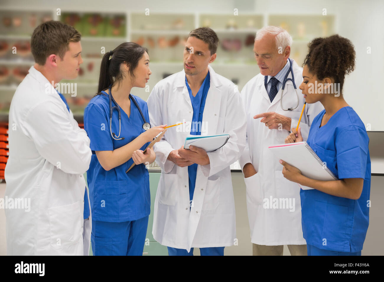 Medical professor talking with students Stock Photo - Alamy
