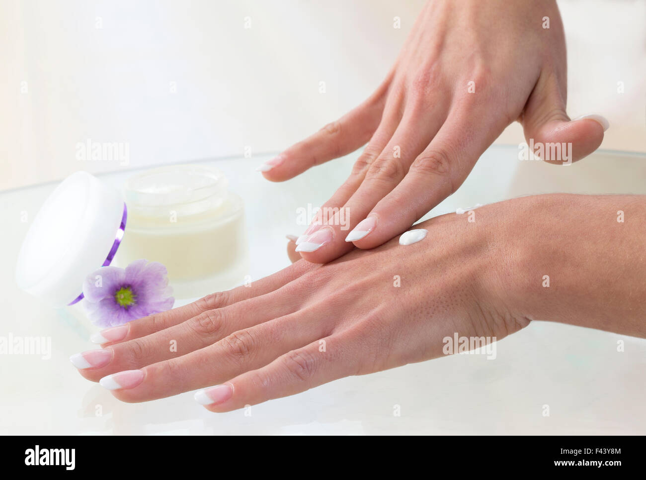 beautiful woman hands with cream applying Stock Photo - Alamy
