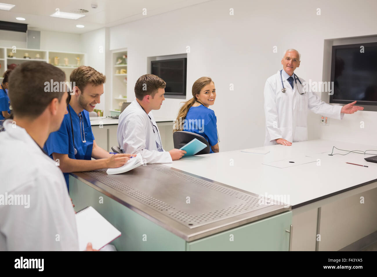 Medical professor teaching young students Stock Photo - Alamy