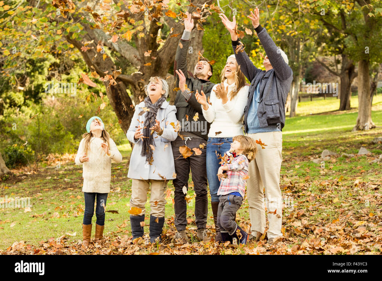 Happy family playing in the park together Stock Photo - Alamy