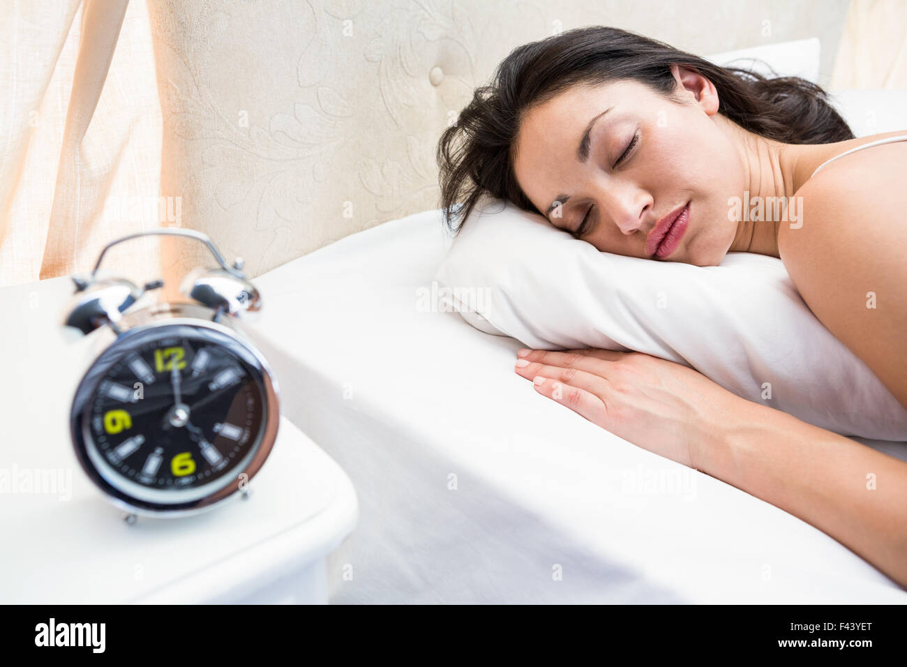 Pretty brunette sleeping on bed Stock Photo - Alamy