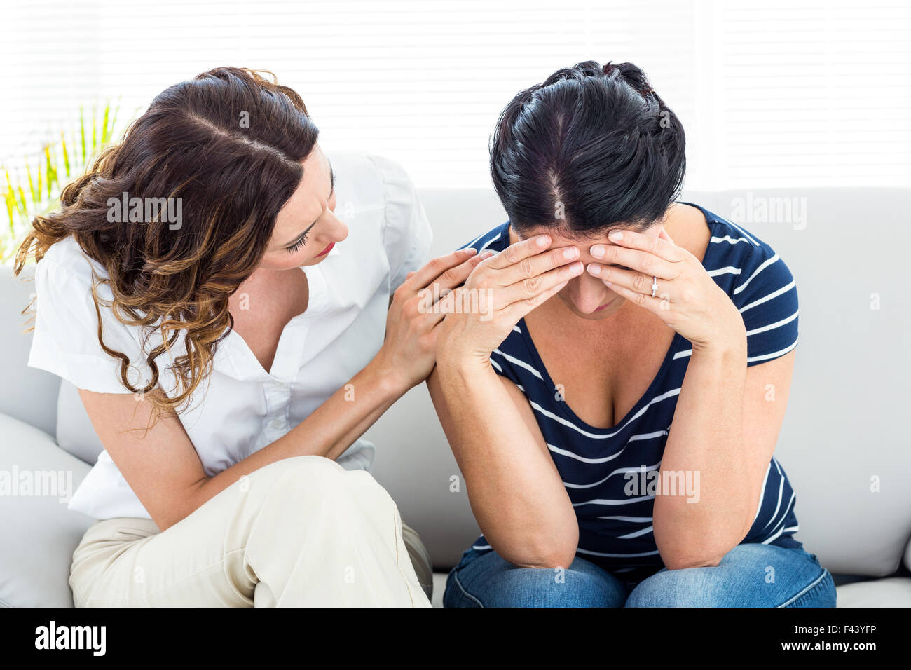 Therapist comforting her patient Stock Photo - Alamy