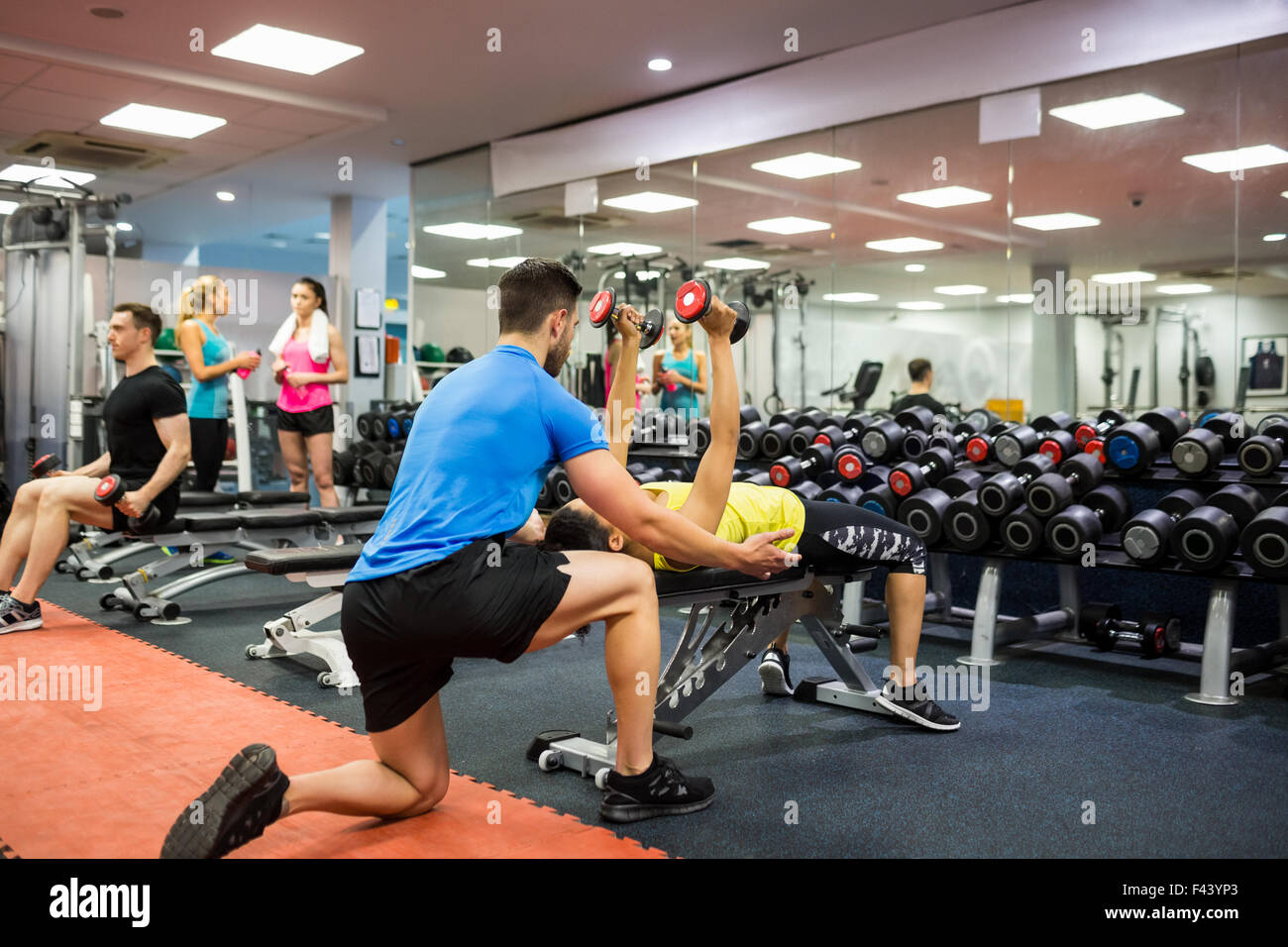 Fit people working out in weights room Stock Photo - Alamy
