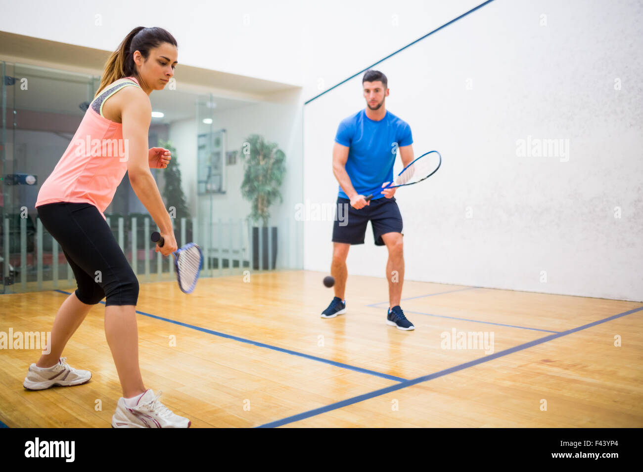 Couple play some squash together Stock Photo - Alamy