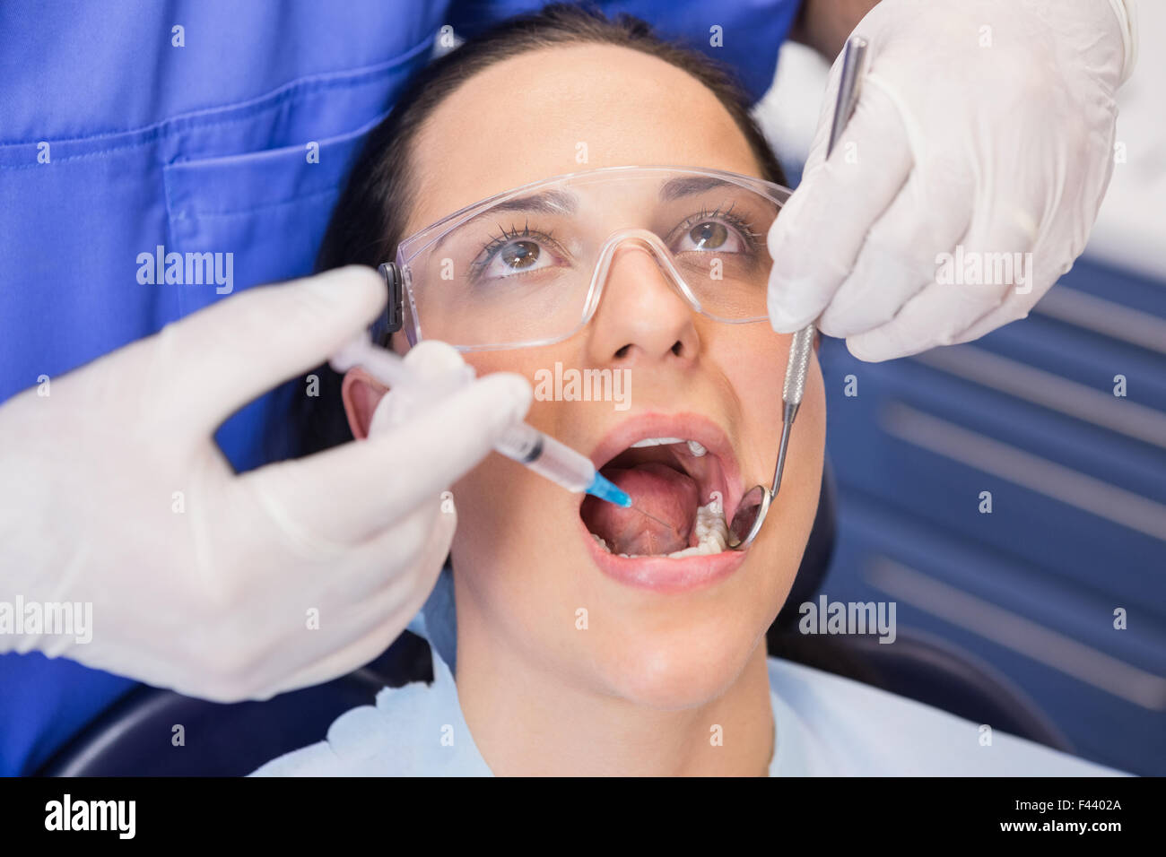 Dentist doing injection to his patient Stock Photo - Alamy
