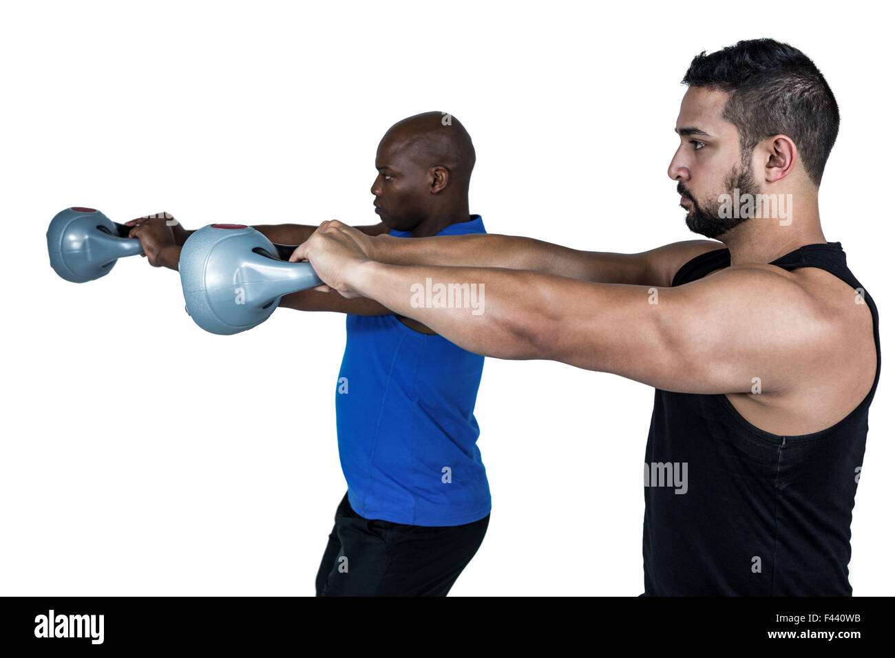 Strong friends lifting kettlebells together Stock Photo - Alamy