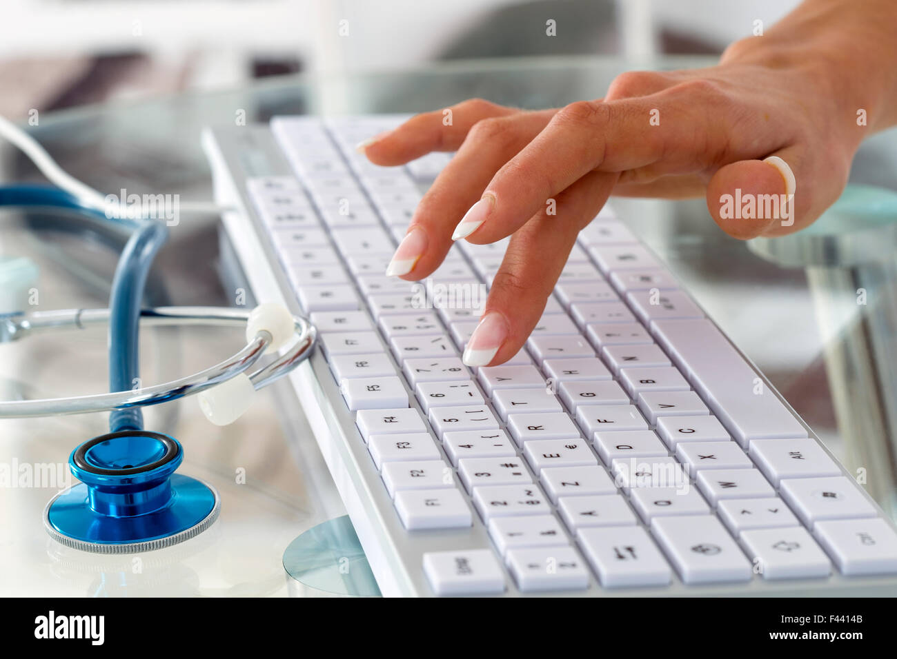 Doctor using computer keyboard with stethoscope Stock Photo - Alamy