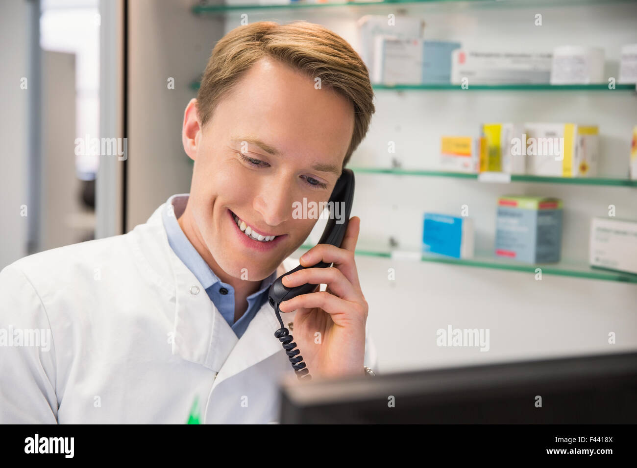 Happy pharmacist on the phone Stock Photo - Alamy