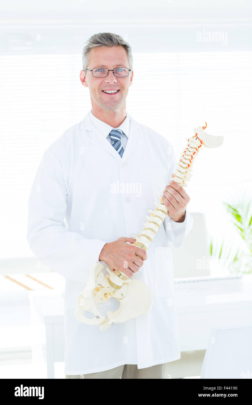 Doctor showing anatomical spine Stock Photo - Alamy