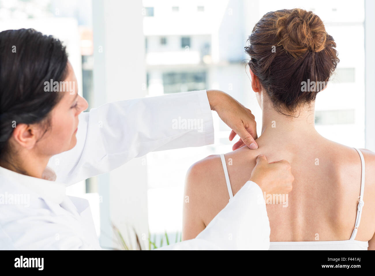 Doctor squeezing her patients spot Stock Photo - Alamy
