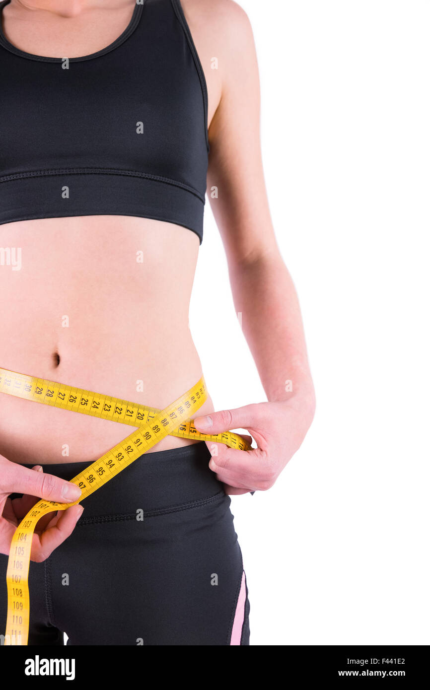 Slim woman measuring waist with tape measure Stock Photo - Alamy