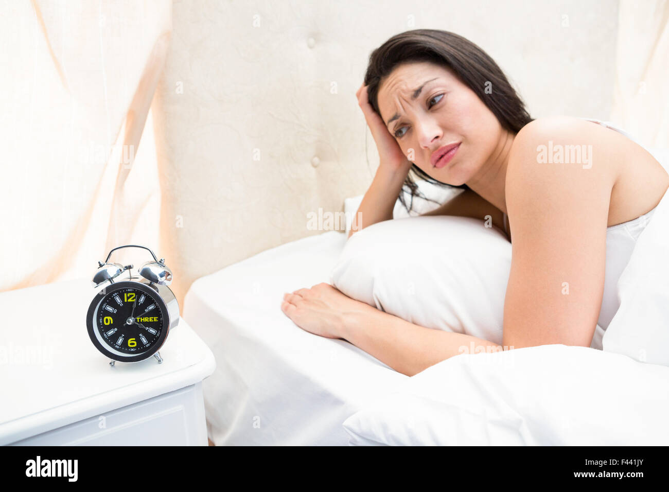 Pretty brunette waking up on bed Stock Photo - Alamy