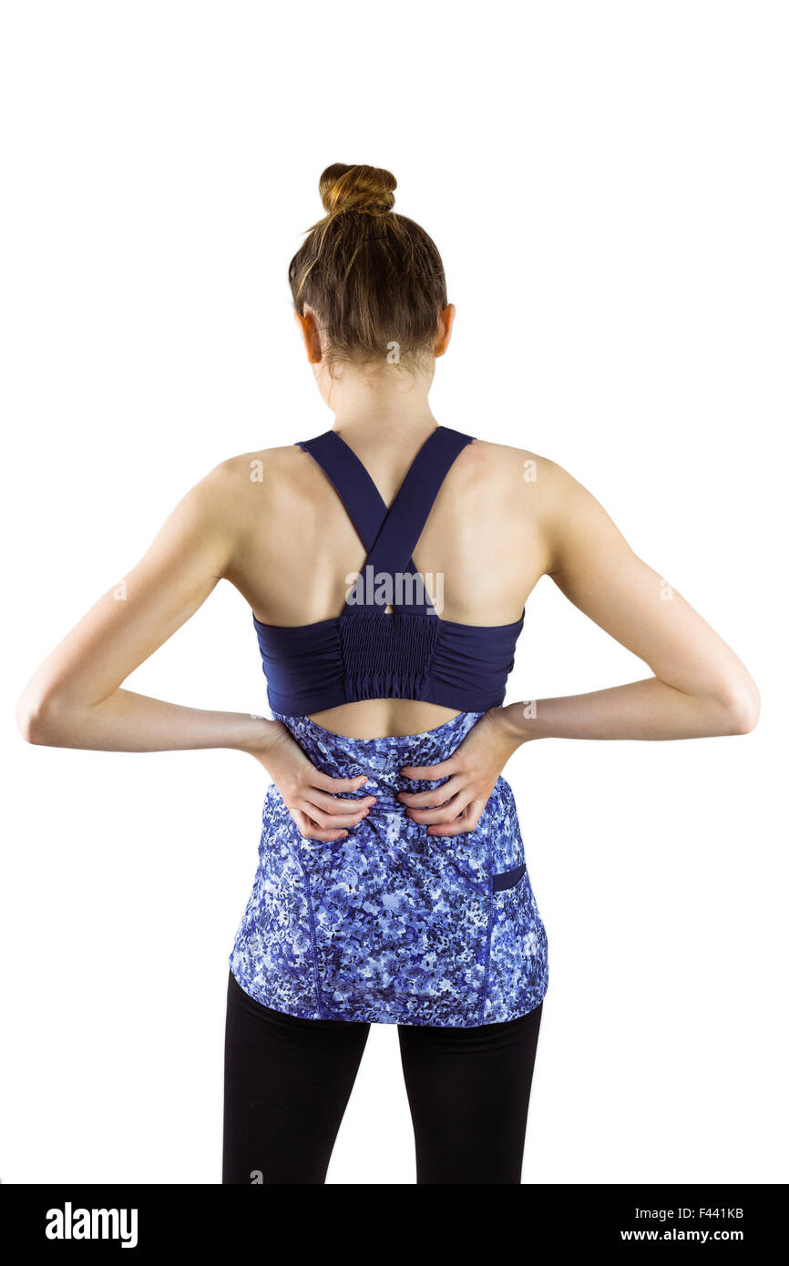Fit brunette with back injury Stock Photo - Alamy