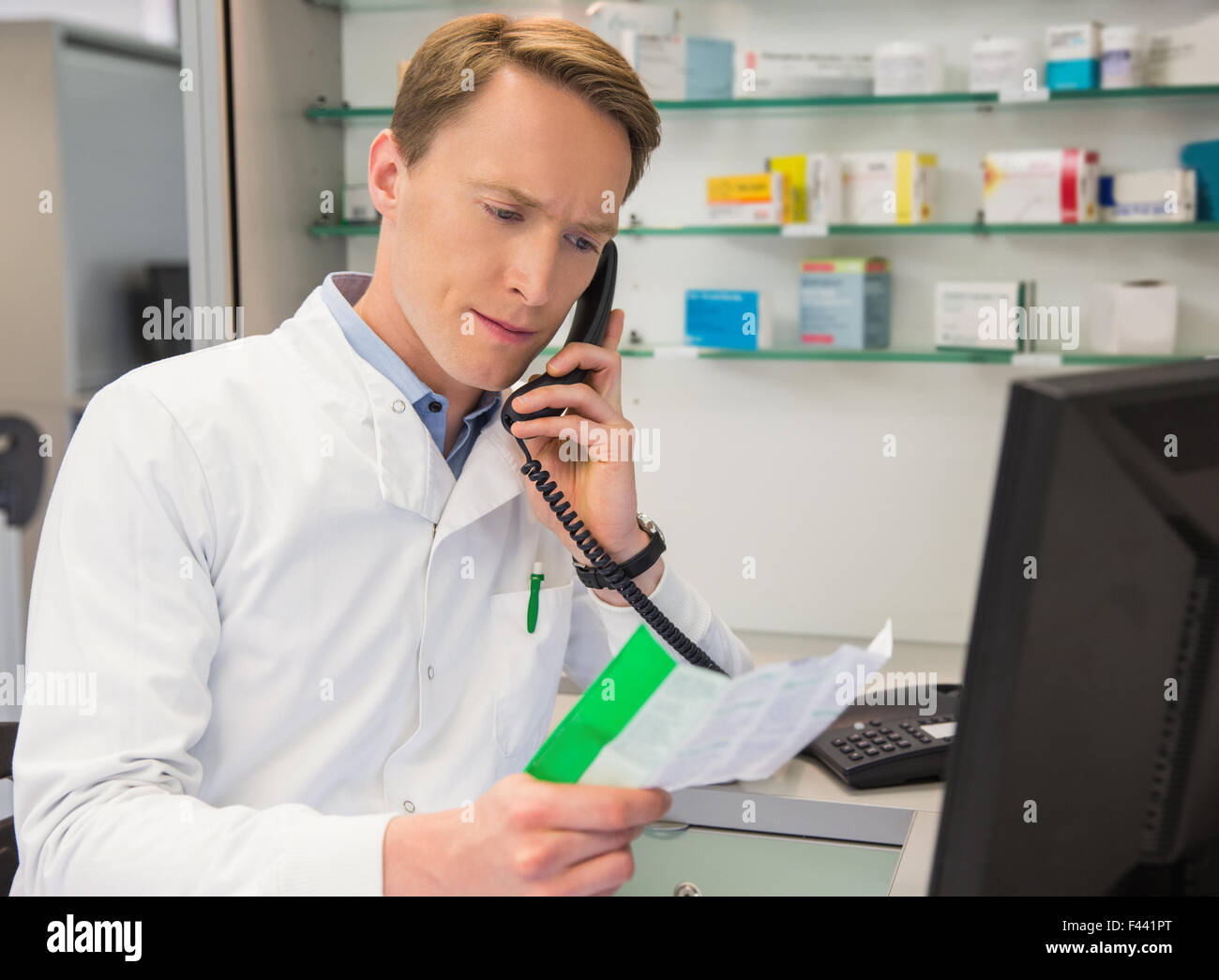 Serious pharmacist on the phone Stock Photo - Alamy