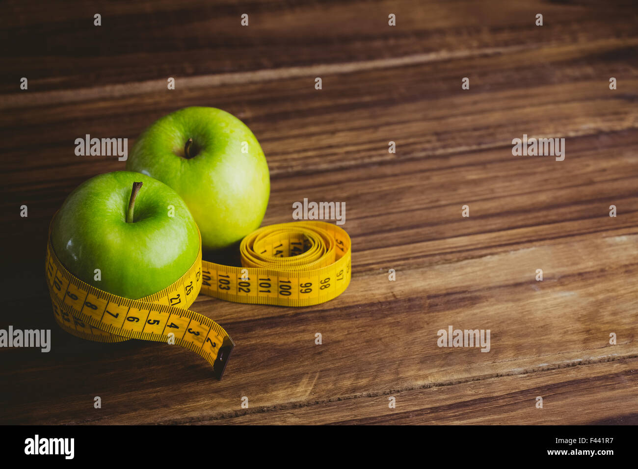 Green apples with measuring tape Stock Photo - Alamy