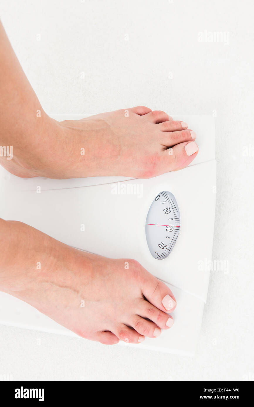 Womans feet on scales Stock Photo - Alamy