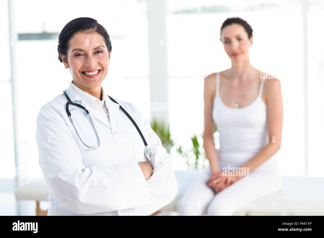 Doctor and patient smiling at camera Stock Photo - Alamy