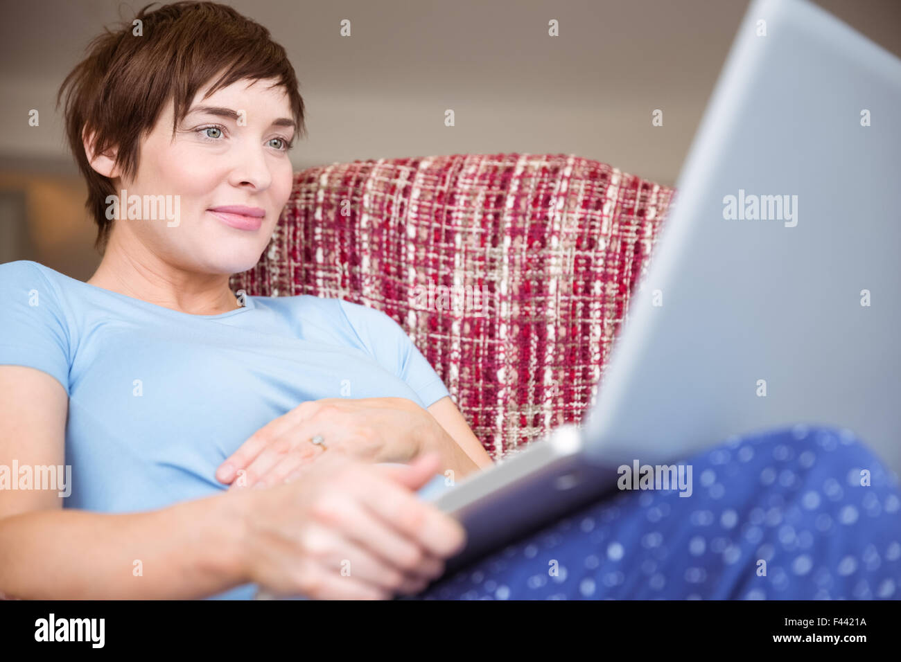 Pregnant woman using her laptop Stock Photo - Alamy