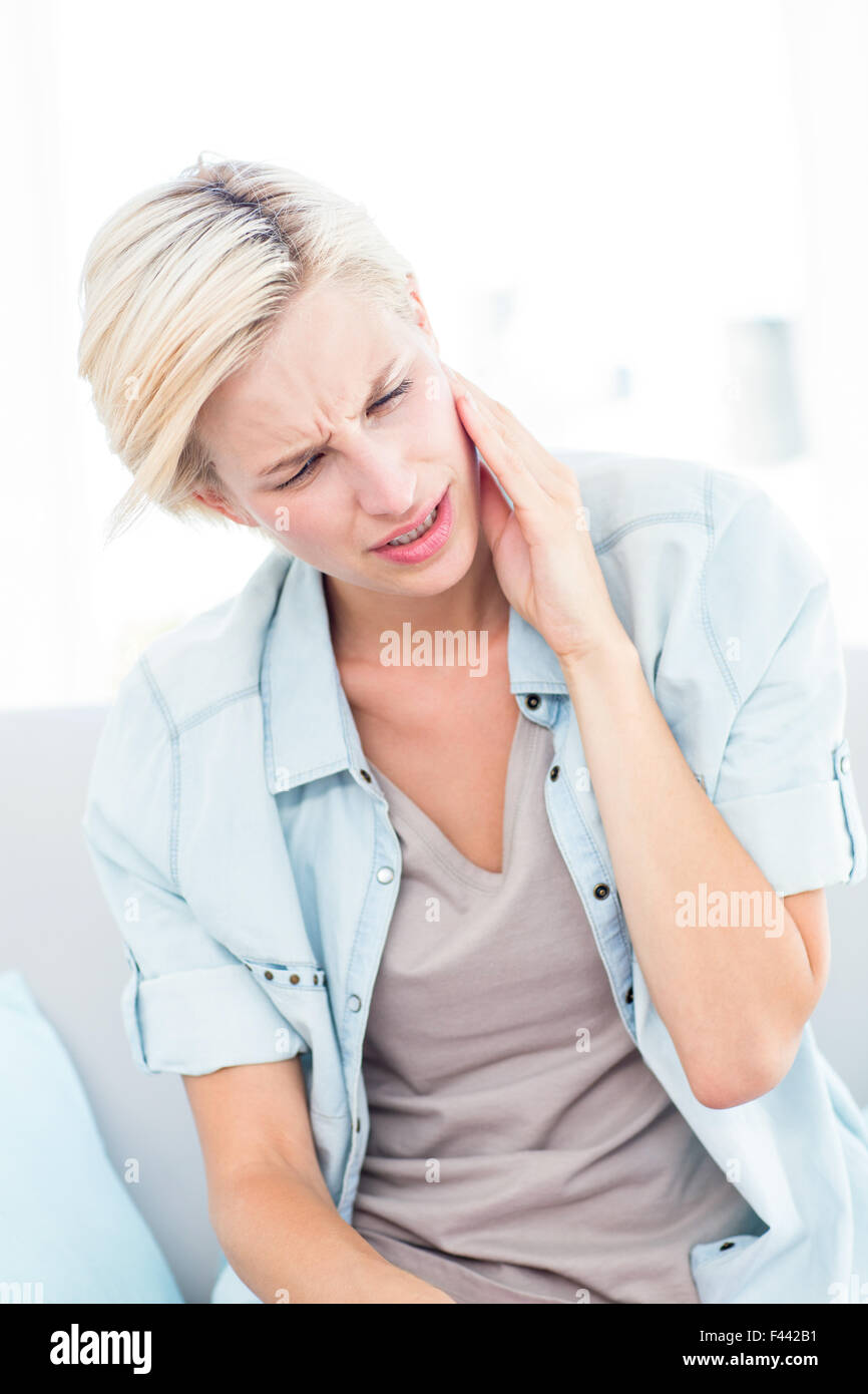 Blonde woman having toothache Stock Photo - Alamy