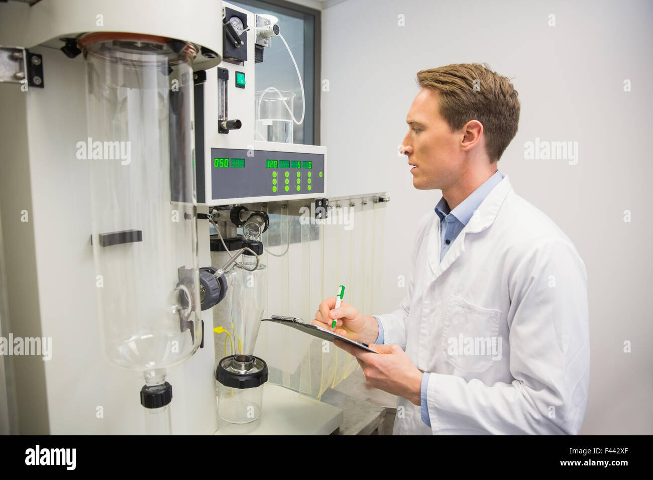 Pharmacist using machinery to make medicine Stock Photo - Alamy