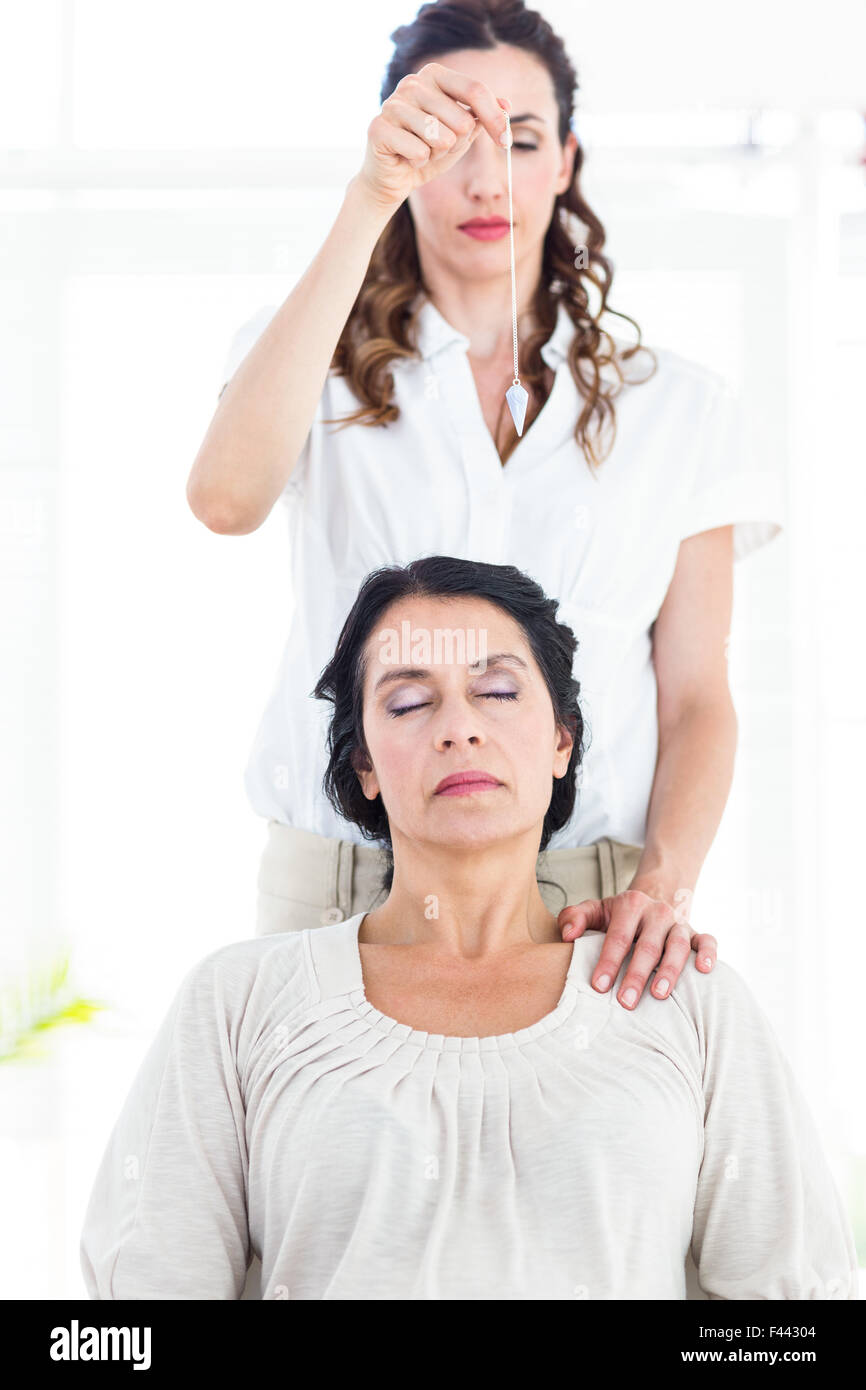 Therapist hypnotizing her patient Stock Photo - Alamy