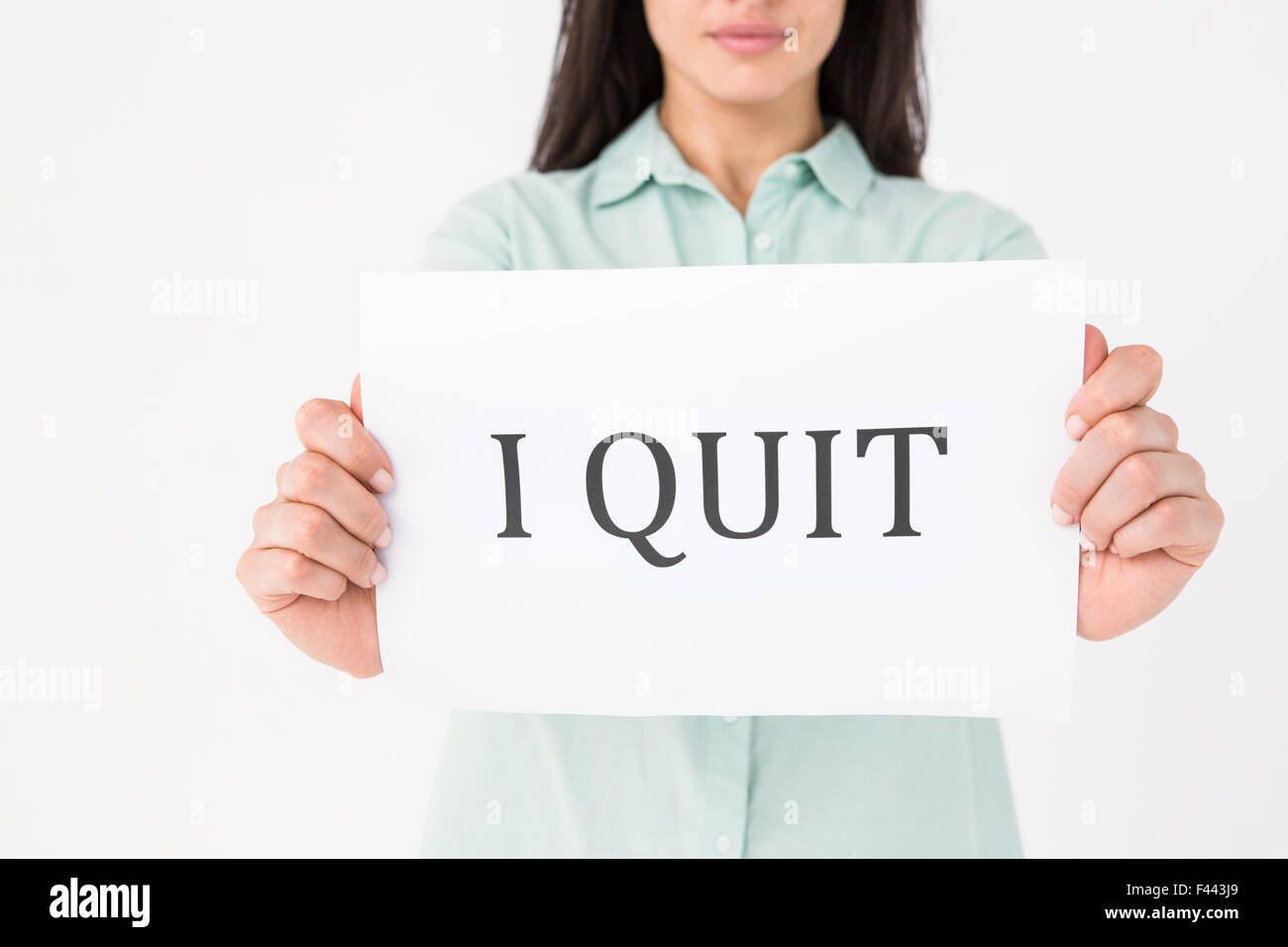 Brunette holding i quit card Stock Photo - Alamy