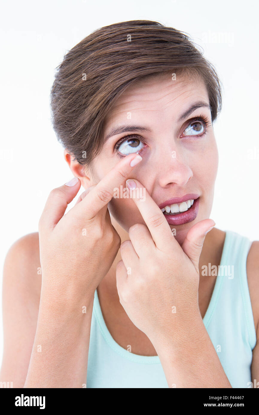 Pretty woman applying contact lens Stock Photo - Alamy