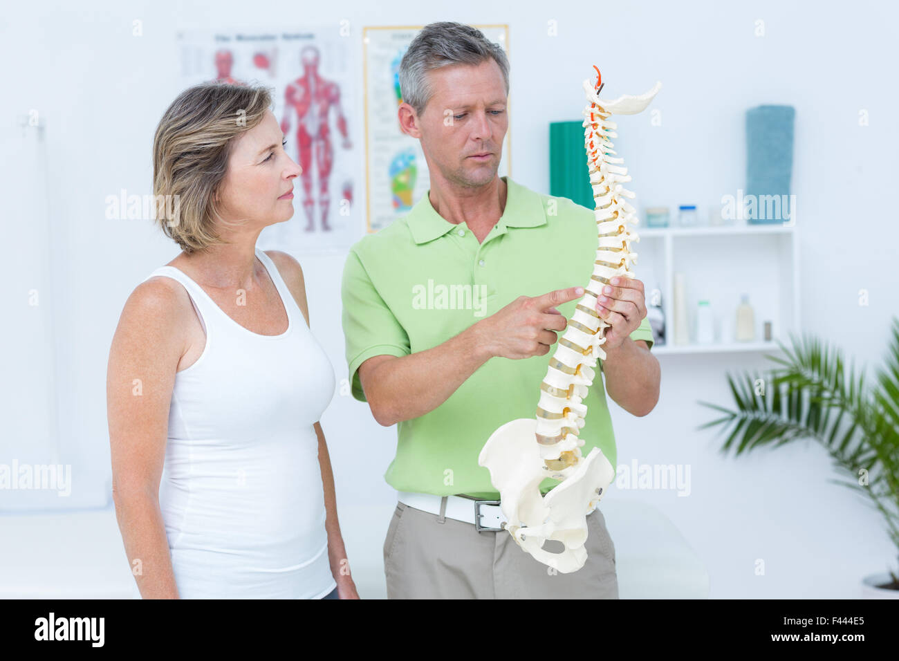 Doctor showing anatomical spine Stock Photo - Alamy