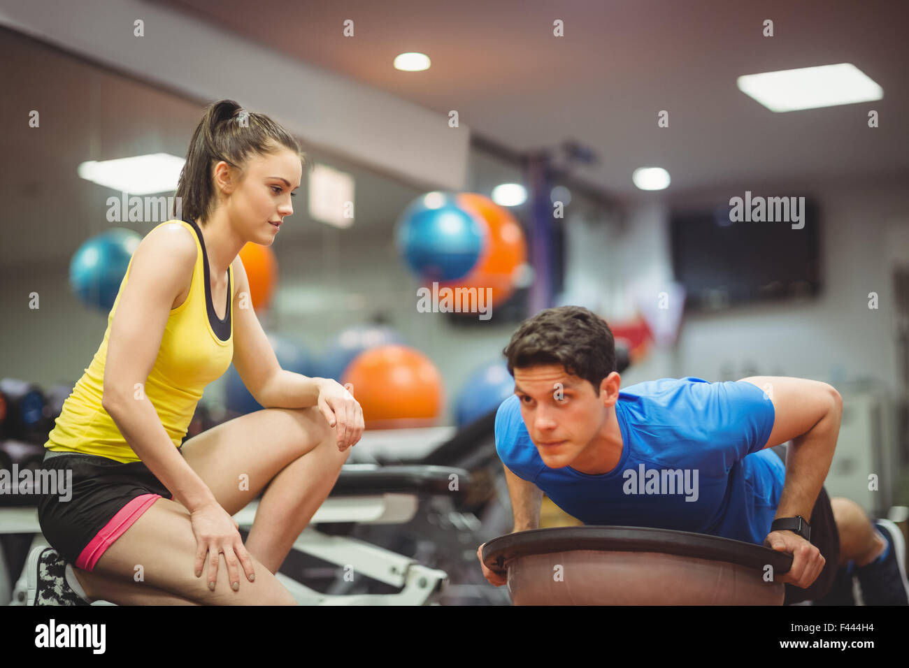 Fit woman working out with trainer Stock Photo - Alamy