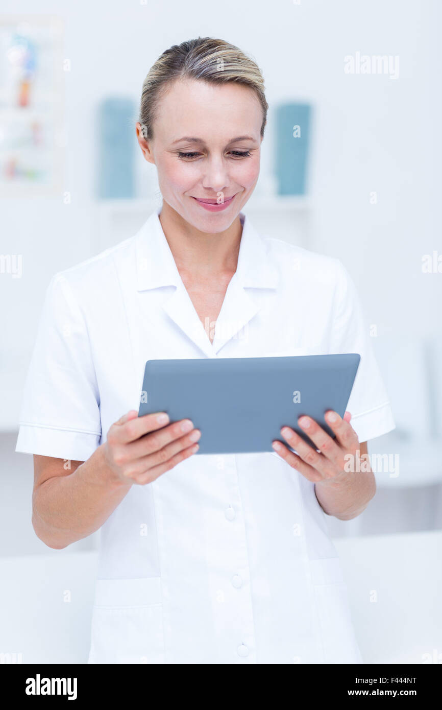Smiling doctor using tablet Stock Photo - Alamy
